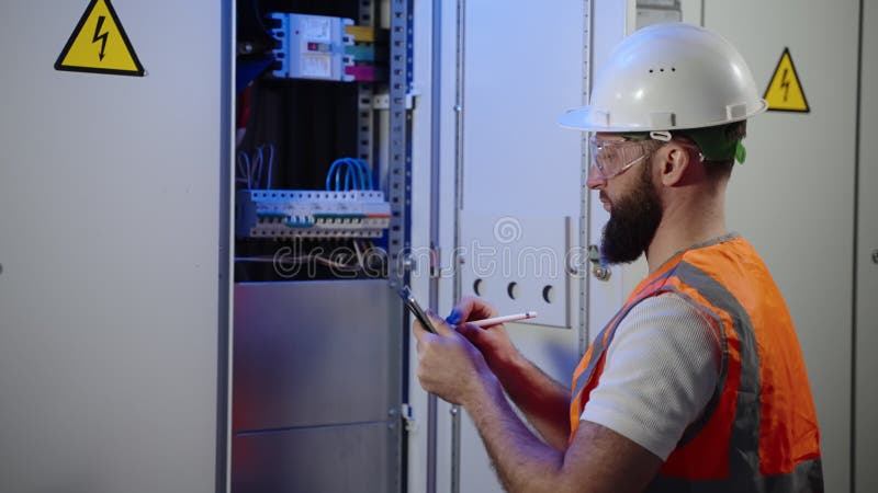 Inspection of Switchboard. Electrician with Digital Tablet Checking ...