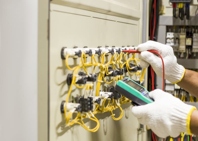 Electrical Engineer Tests the Operation of the Electric Control Cabinet ...