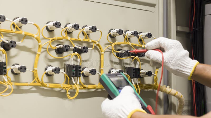 Electrical Engineer Tests the Operation of the Electric Control Cabinet ...
