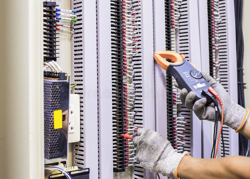 Electrical Engineer Tests the Operation of the Electric Control Cabinet ...