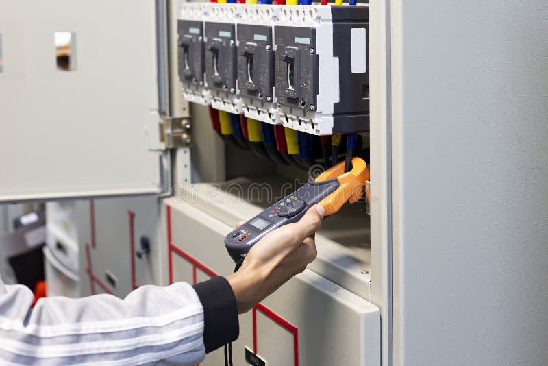 Electrical Engineer Tests the Operation of the Electric Control Cabinet ...