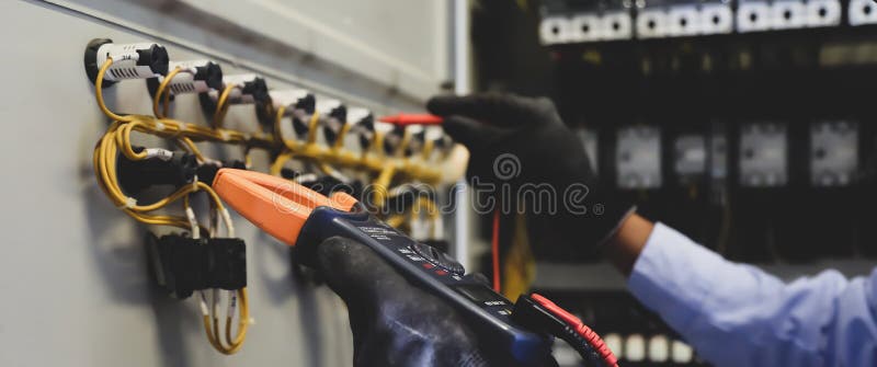 Electrical Engineer Using Digital Multi-meter To Check Current Voltage ...