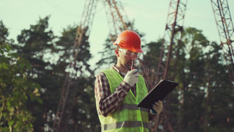 Electrical Engineer Wearing Hard Hat and Safety Vest Checking ...