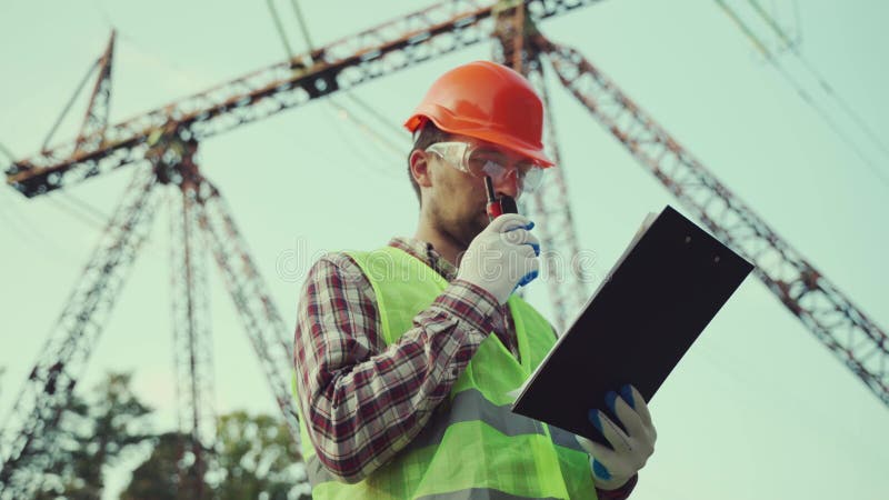 Electrical Engineer Wearing Hard Hat and Safety Vest Checking ...