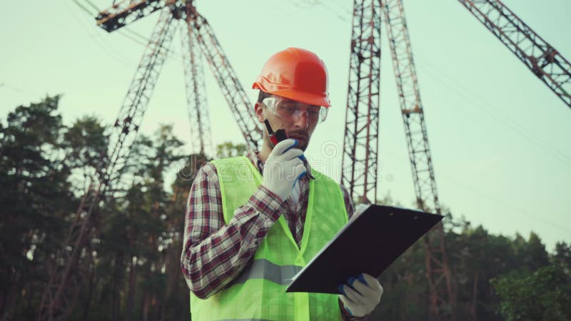 Electrical Engineer Wearing Hard Hat and Safety Vest Checking ...