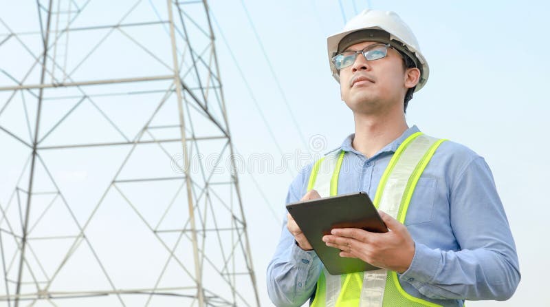 Electrical Engineer Working on Digital Tablet with Electric Power Pole ...