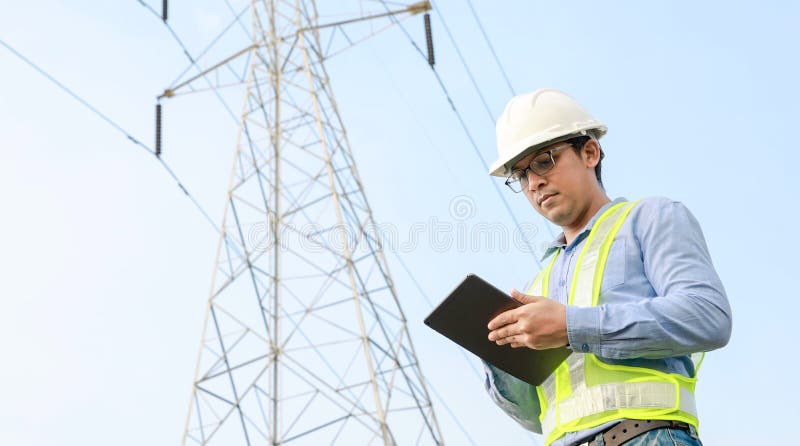 Electrical Engineer Working on Digital Tablet with Electric Power Pole ...