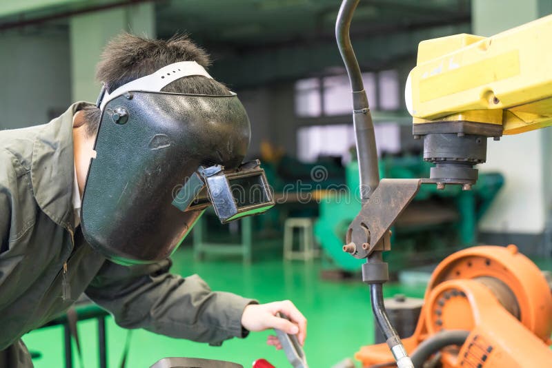 Electrical Engineer Working with a Robot Stock Image - Image of machine ...