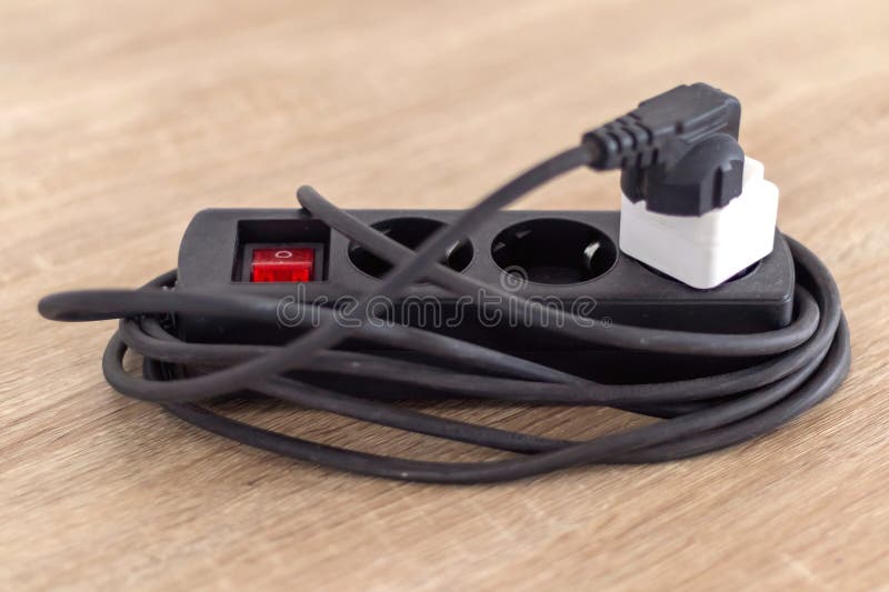 An Electrical Extension Cord Socket on Wooden Table Stock Image - Image ...