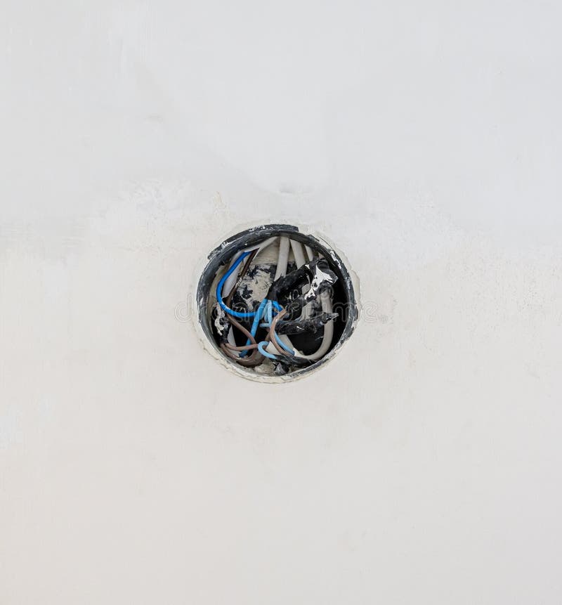 An Electrical Junction Box on a White Wall. the Electrical Wires Start ...