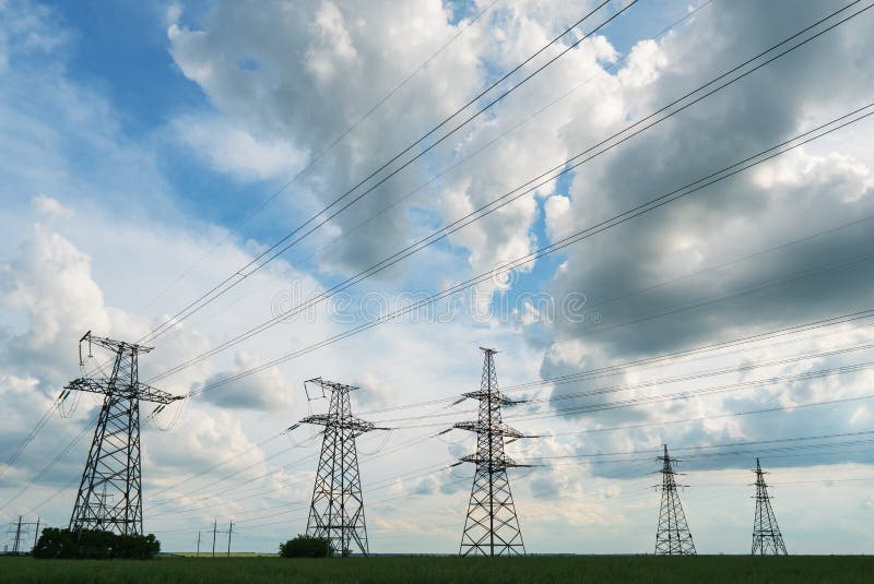 Electrical Net of Poles on a Panorama of Blue Sky and Green Meadow ...