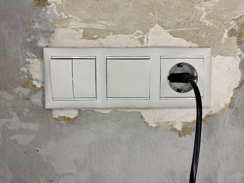 Electrical Outlet with Cord on Plain Grey Background for Minimalistic ...