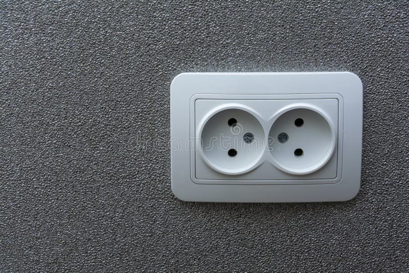 An Electrical Outlet on a Gray, Textured Wall. Image for Project and ...