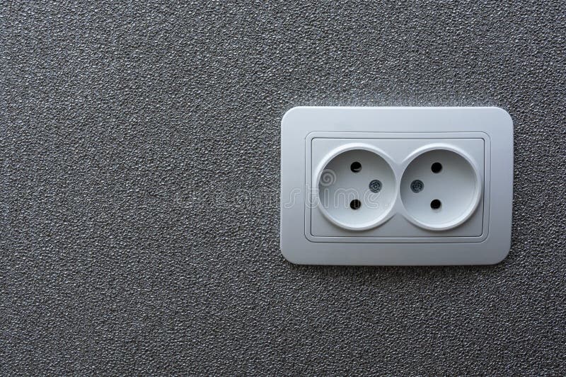 An Electrical Outlet on a Gray, Textured Wall. Image for Project and ...