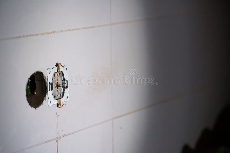 Electrical Outlet Installation with Exposed Wiring in a Tiled Wall ...