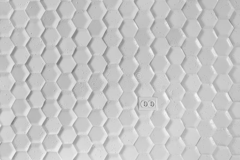 Electrical Outlet on the Wall of White Tiles in the Form of a Honeycomb ...
