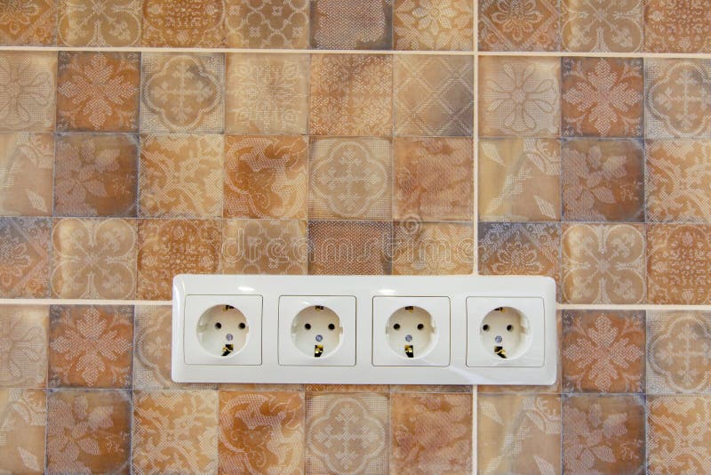 Electrical Outlets on Beige Tiles with a Vegetable Pattern Stock Photo ...