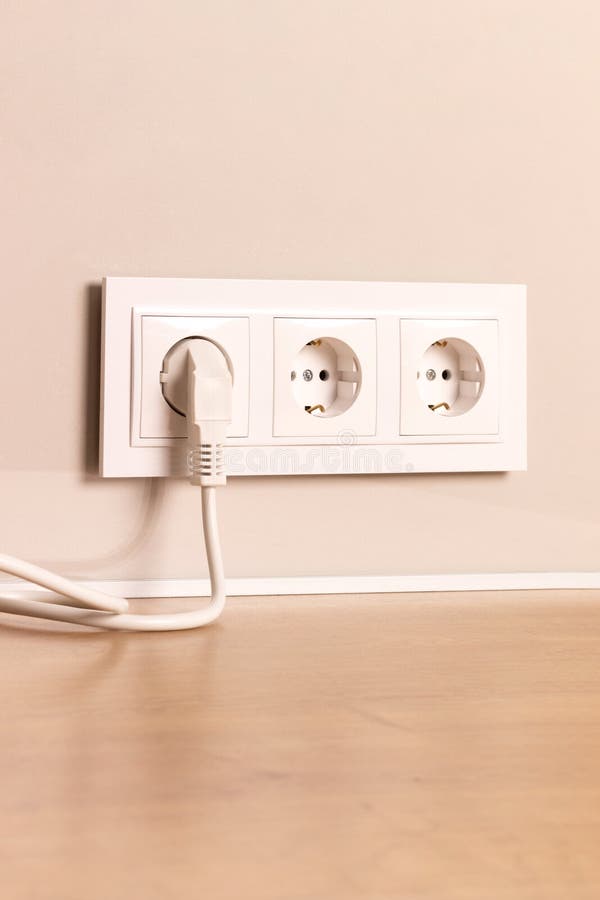 Electrical Outlets with Plug on Beige Wall Stock Image - Image of wall ...