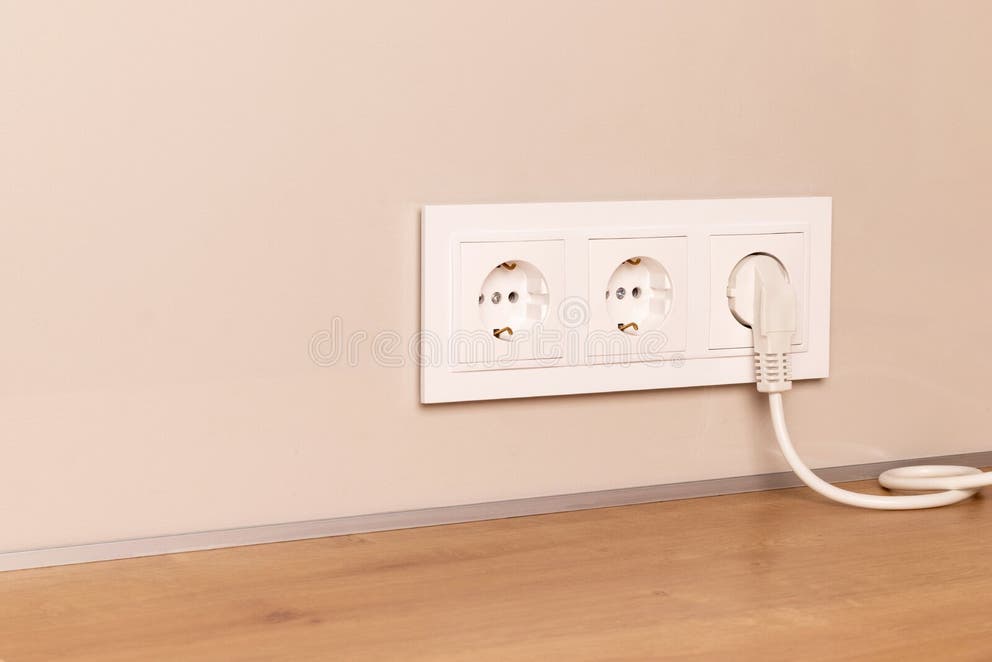 Electrical Outlets with Plug on Beige Wall Stock Photo - Image of ...