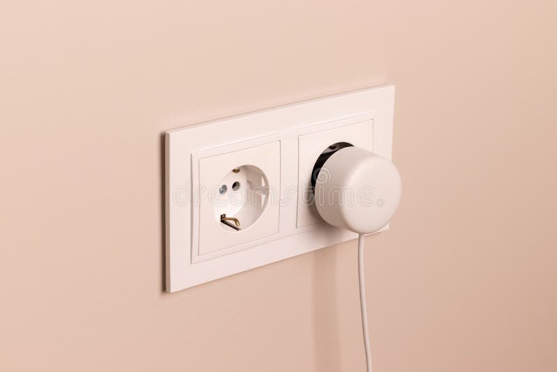 Electrical Outlets with Plug on Beige Wall Stock Photo - Image of ...