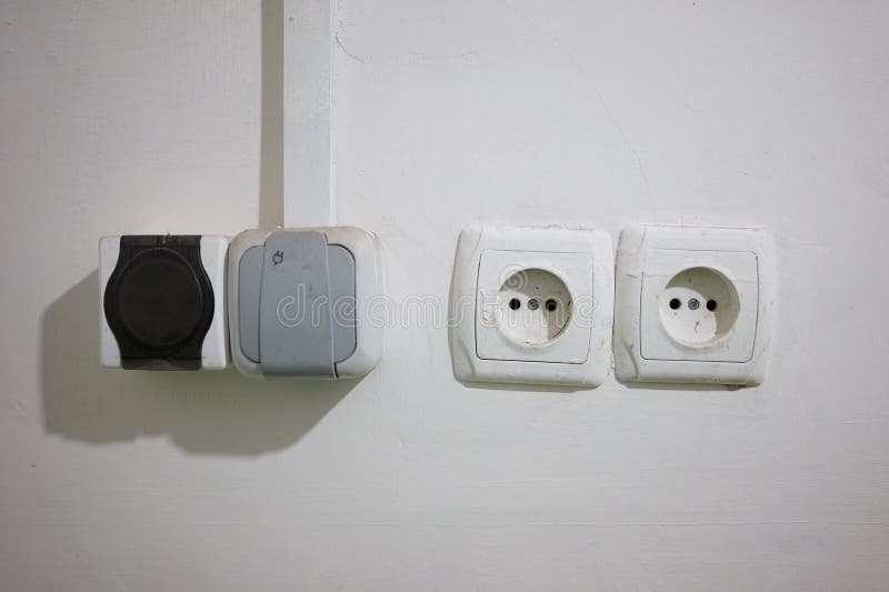 Electrical Outlets and Switches on a Plain White Wall in a Home ...