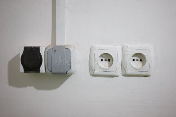Electrical Outlets and Switches on a Plain White Wall in a Home ...