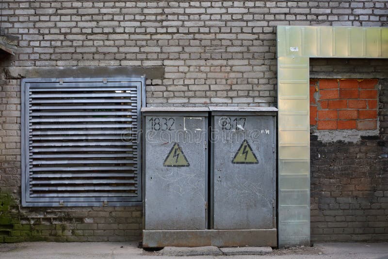 Electrical Panels Against a Gray Brick Wall with a Ventilation Window ...