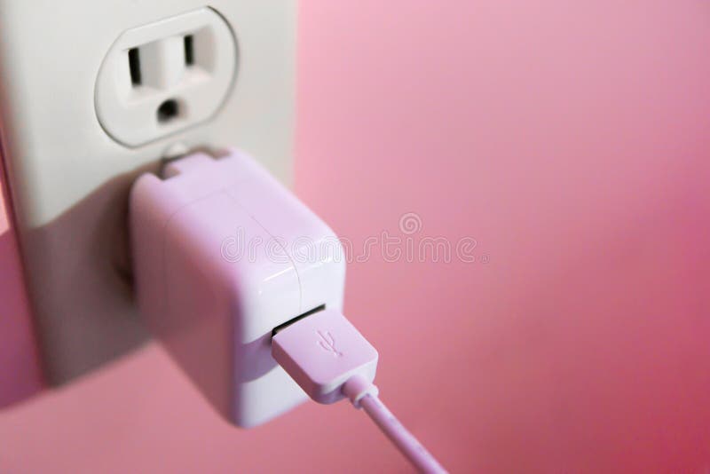 An Electrical Plug on a Pink Wall with a Tablet USB Plug Stock Image ...