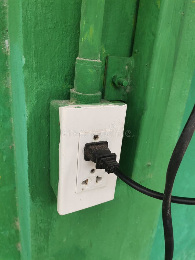 Electrical Plug and Socket on Green Wall, Closeup of Photo Stock Image ...