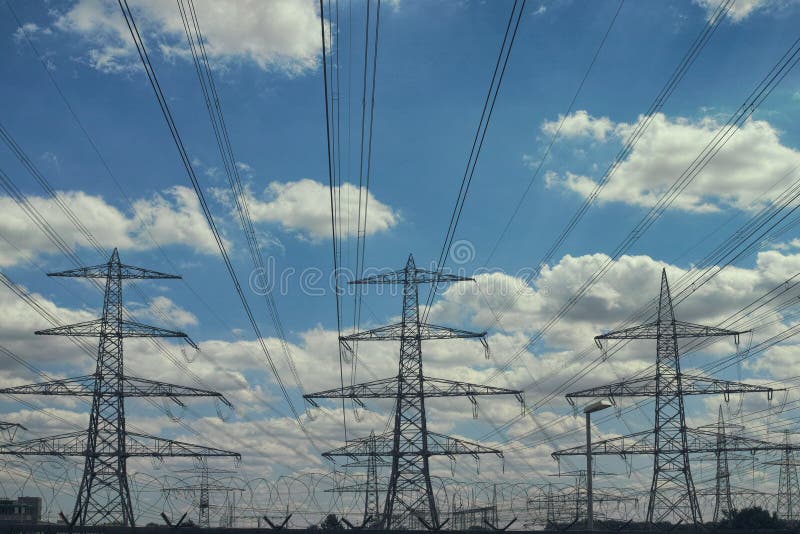 Electrical Power Lines As Sun Sets in Background Blue Stock Photo ...