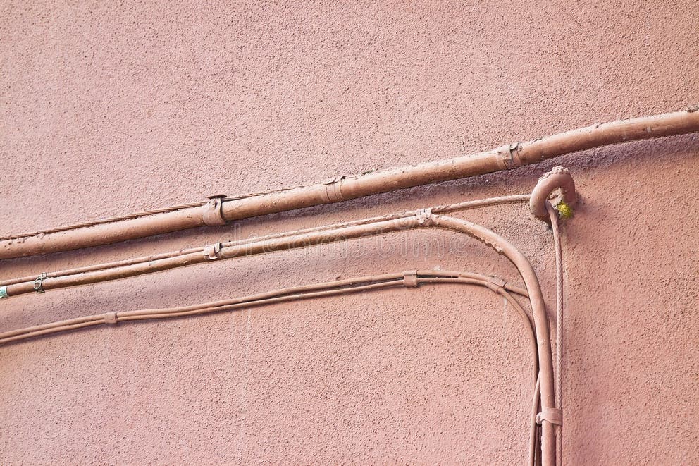 Electrical Power and Telephone Cables Against a Plaster Wall Stock ...