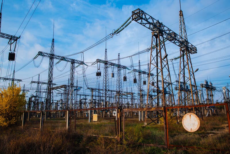 Electrical Pylons and High Voltage Power Lines are Behind a Barbed Wire ...