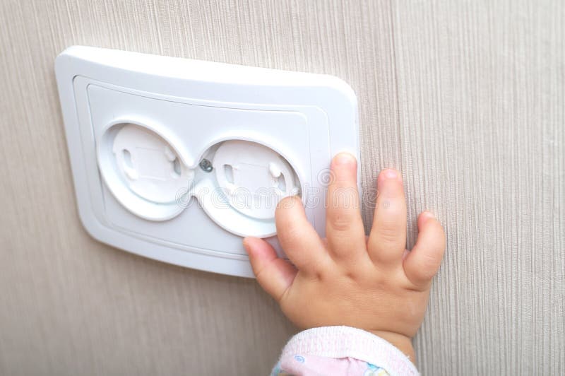 Baby touching power socket stock photo. Image of point - 6121392