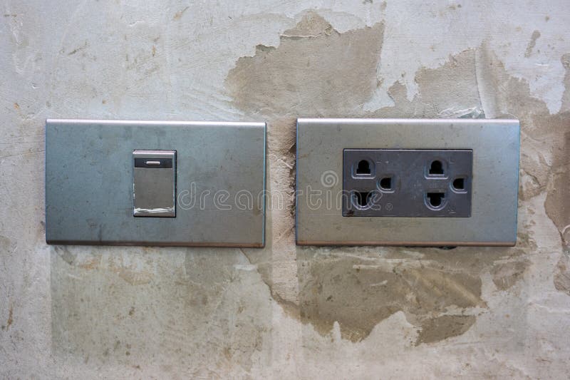 Electrical Switch and Electric Outlet on a Old Wall Concrete Stock ...