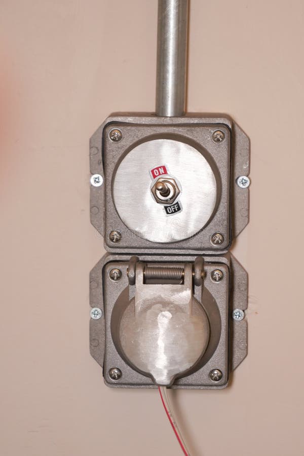 Electrical Switch and Outlet Mounted on a Wall Near Equipment Stock ...
