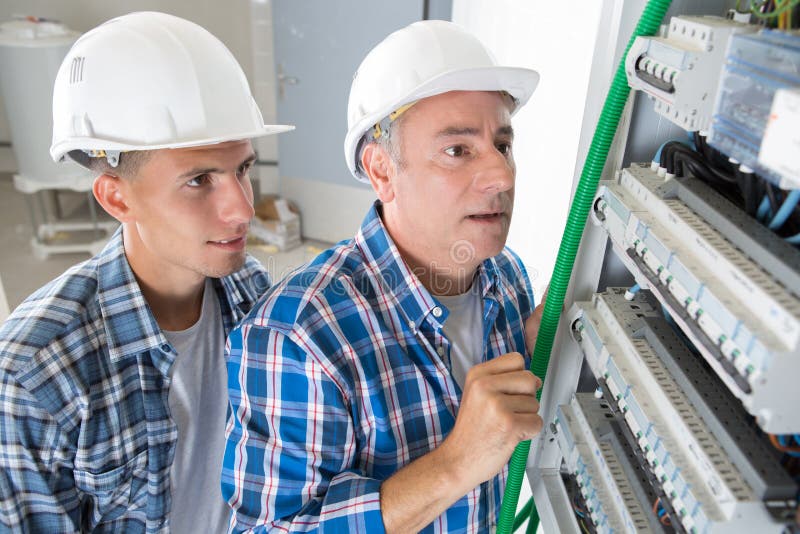 Electrical Team Installing Fuse Box Stock Photo - Image of blue ...