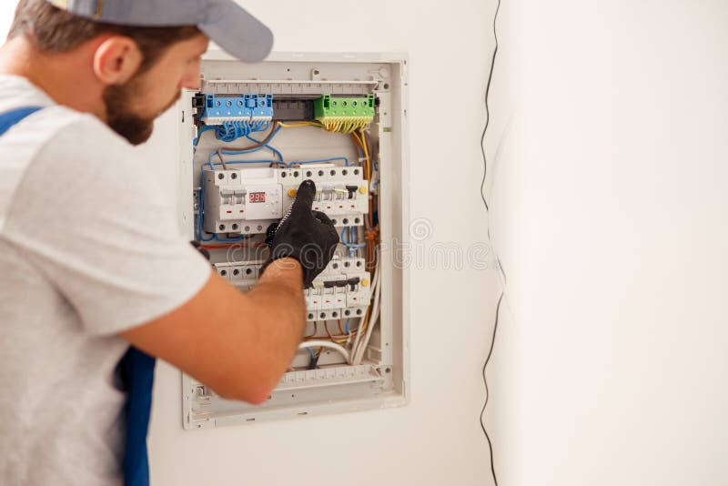 Electrical Technician in Uniform Looking Focused while Working in a ...