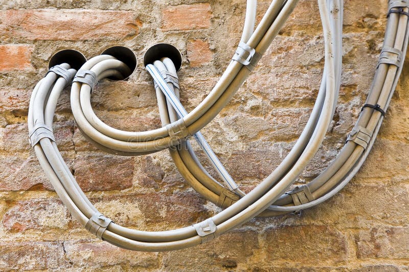 ELECTRICAL and TELEPHONE CABLES Mounted Externally on a Building Wall ...