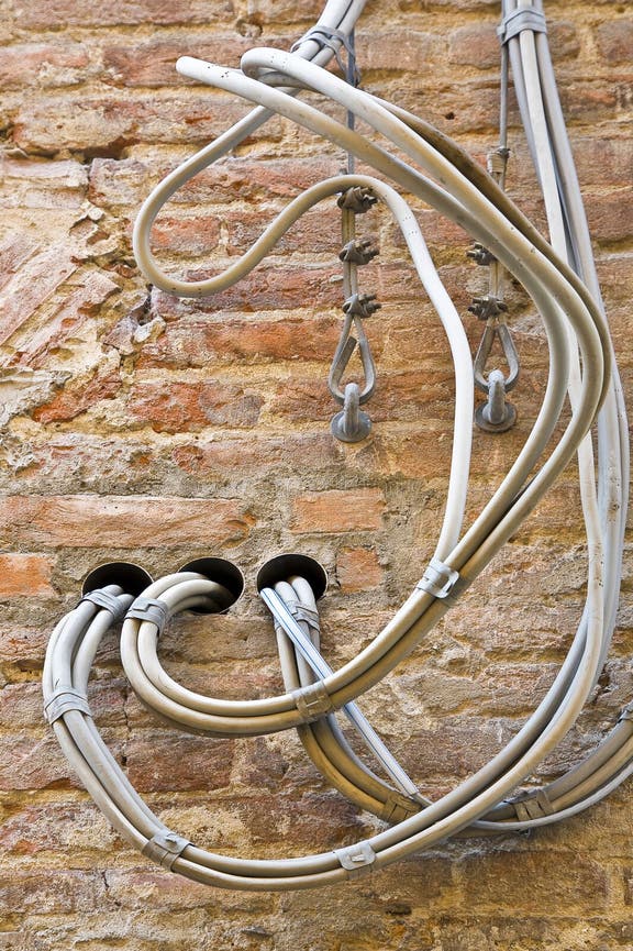 ELECTRICAL and TELEPHONE CABLES Mounted Externally on a Building Wall ...