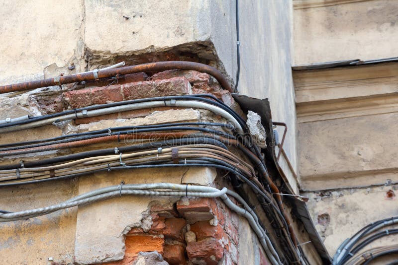 Electrical, Telephone and Internet Cables on an Old Brick Wall Close-up ...