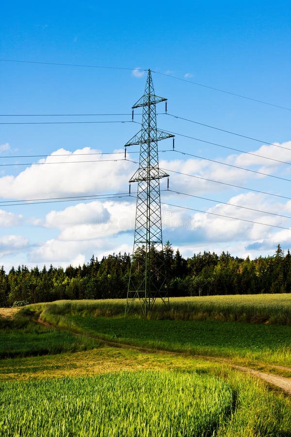 Electrical Tower with Power Lines in a Field Under a Blue Sky. Stock ...