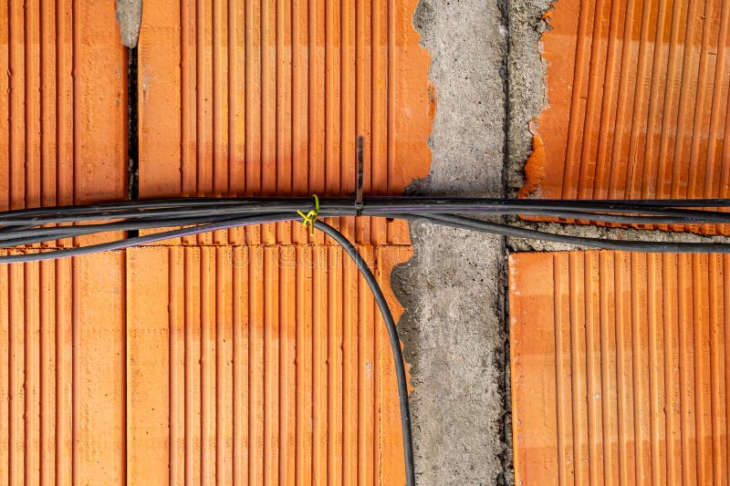 Electrical Wiring Being Installed on a Brick Wall during Construction ...