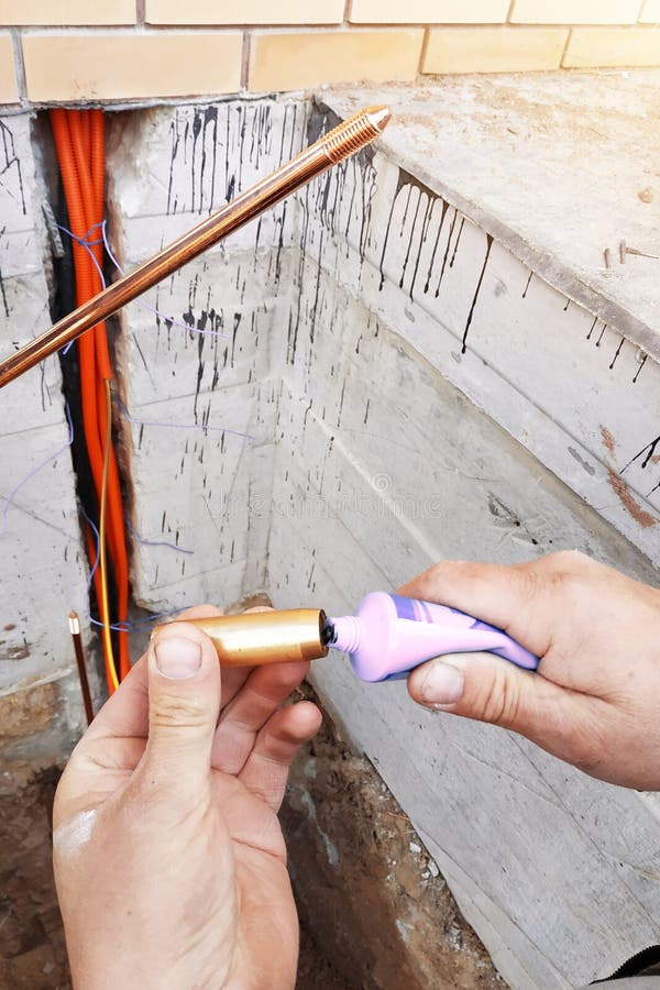 The Electrical Wizard Conducts Protective Grounding Near the House ...