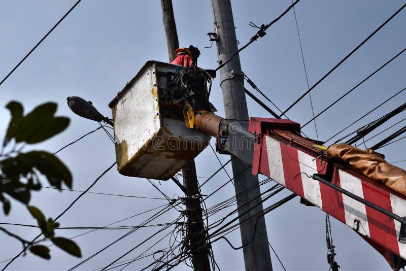 Electrical Workers on Telehandler with Bucket Installing High Tension ...