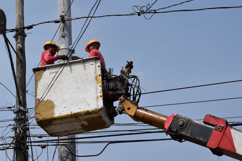 Electrical Workers on Telehandler with Bucket Installing High Tension ...