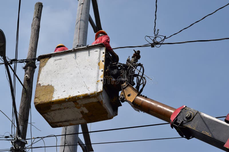 Electrical Workers on Telehandler with Bucket Installing High Tension ...