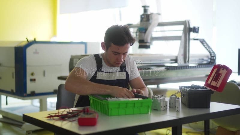 Electrician Assembles Electrical Panel Fuse Box in Workshop. Worker ...