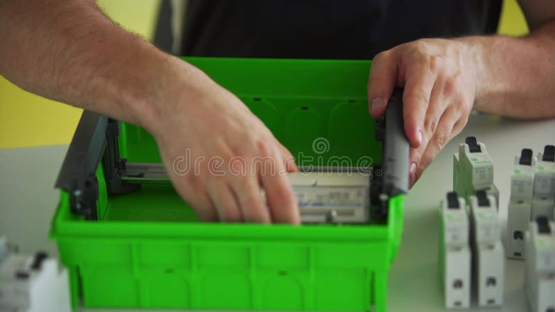 Electrician Assembles Electrical Panel Fuse Box in Workshop. Worker ...
