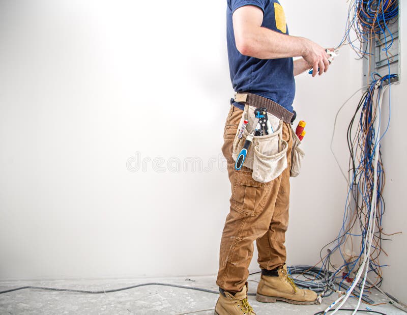 Electrician Builder at Work, Examines the Cable Connection in the ...
