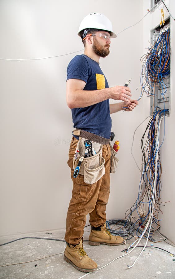Electrician Builder at Work, Examines the Cable Connection in the ...